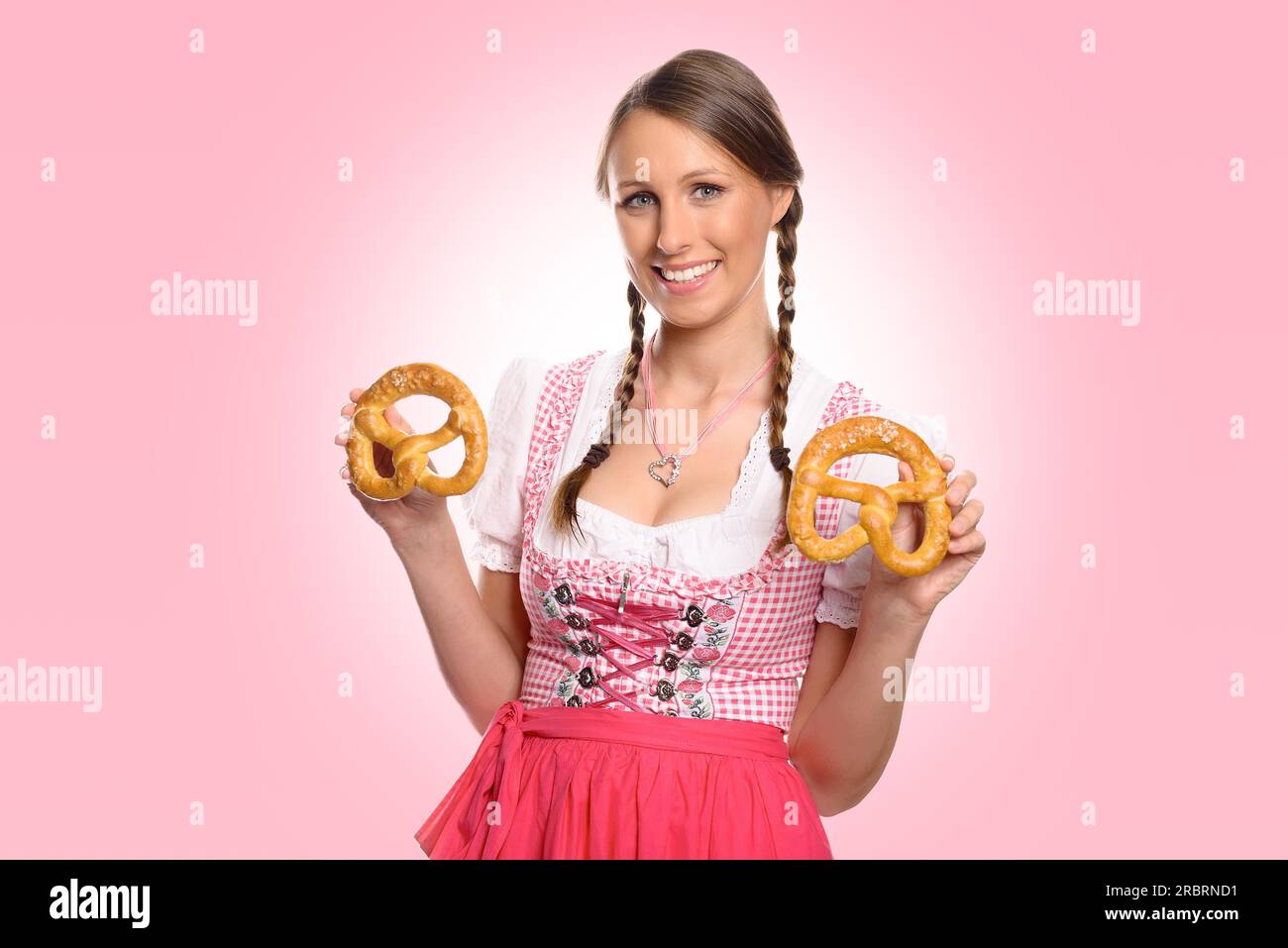 German or Bavarian waitress with her hair in pigtails wearing a ...