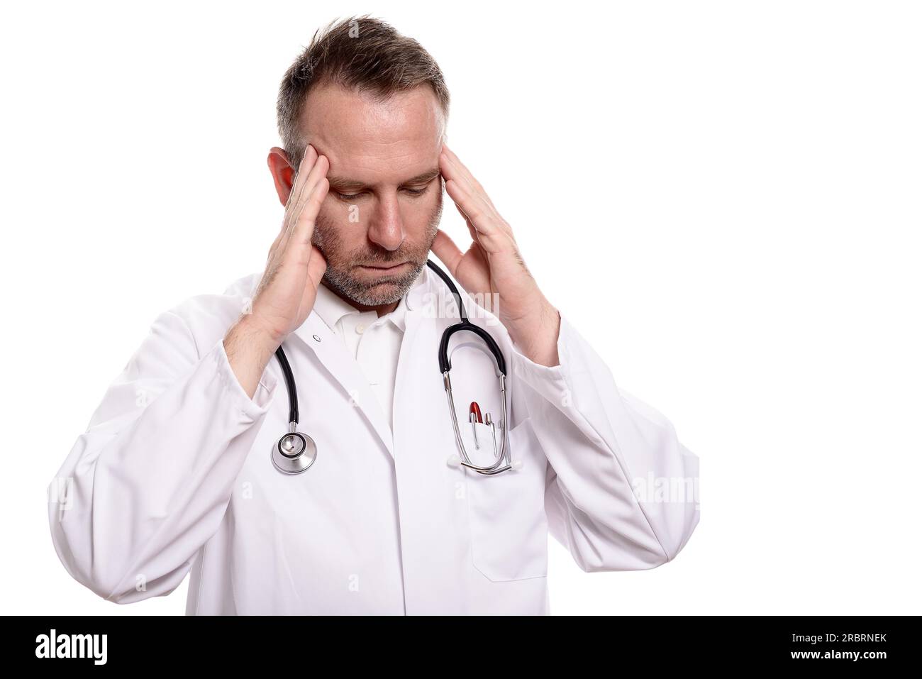Male doctor suffering from a headache and fatigue holding his temples ...