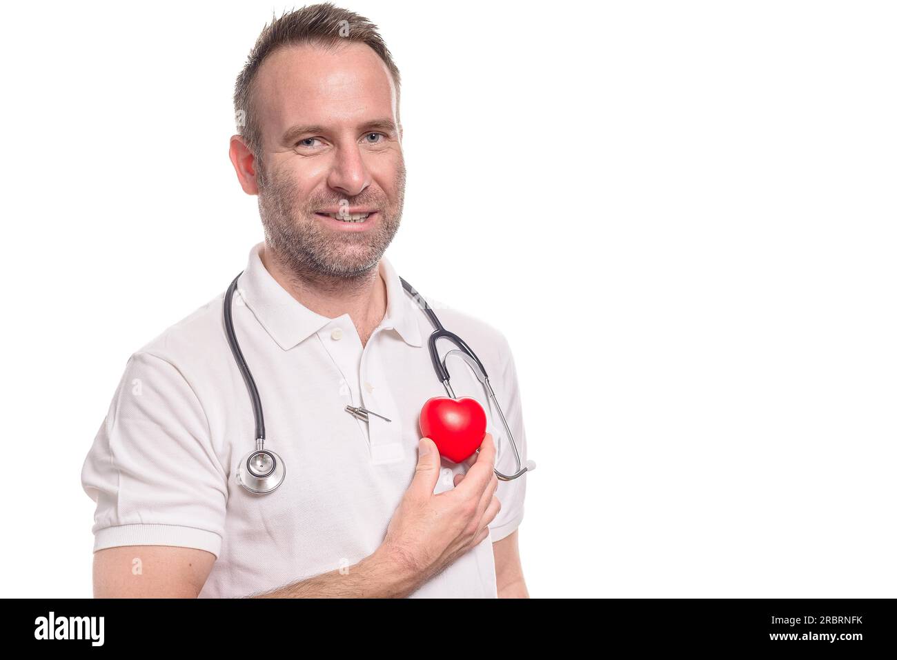 Middle-aged unshaven male cardiologist or doctor holding a red heart to ...