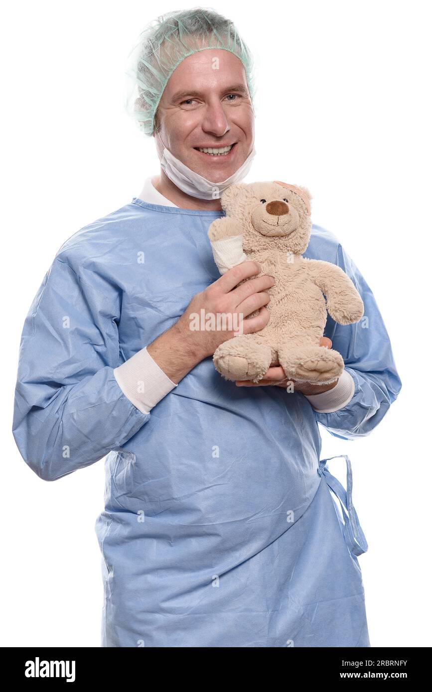 Friendly smiling middle-aged male paediatrician wearing blue scrubs ...