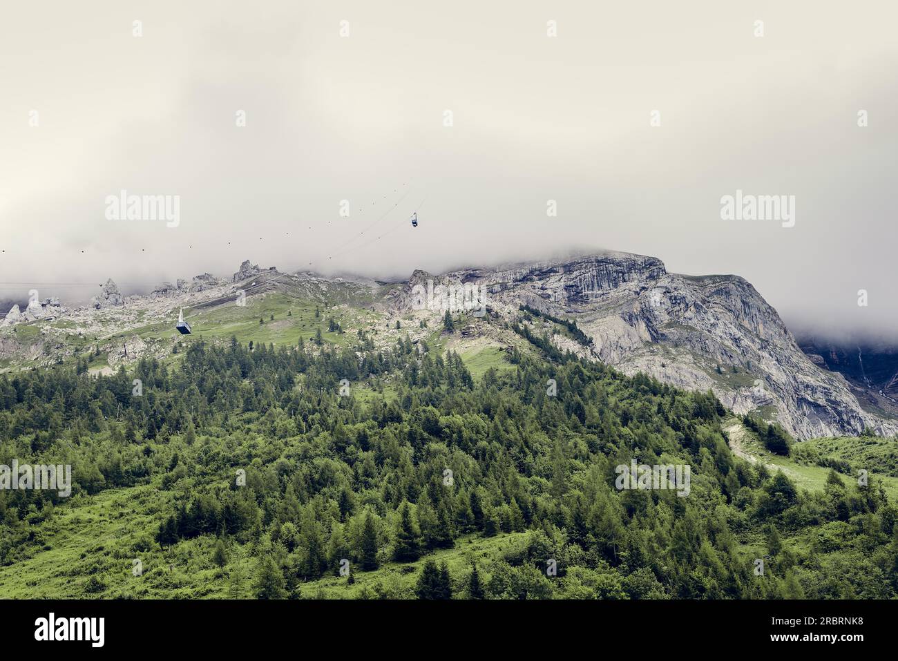 Scenic landscape of misty mountain peaks with forested slopes and a ...