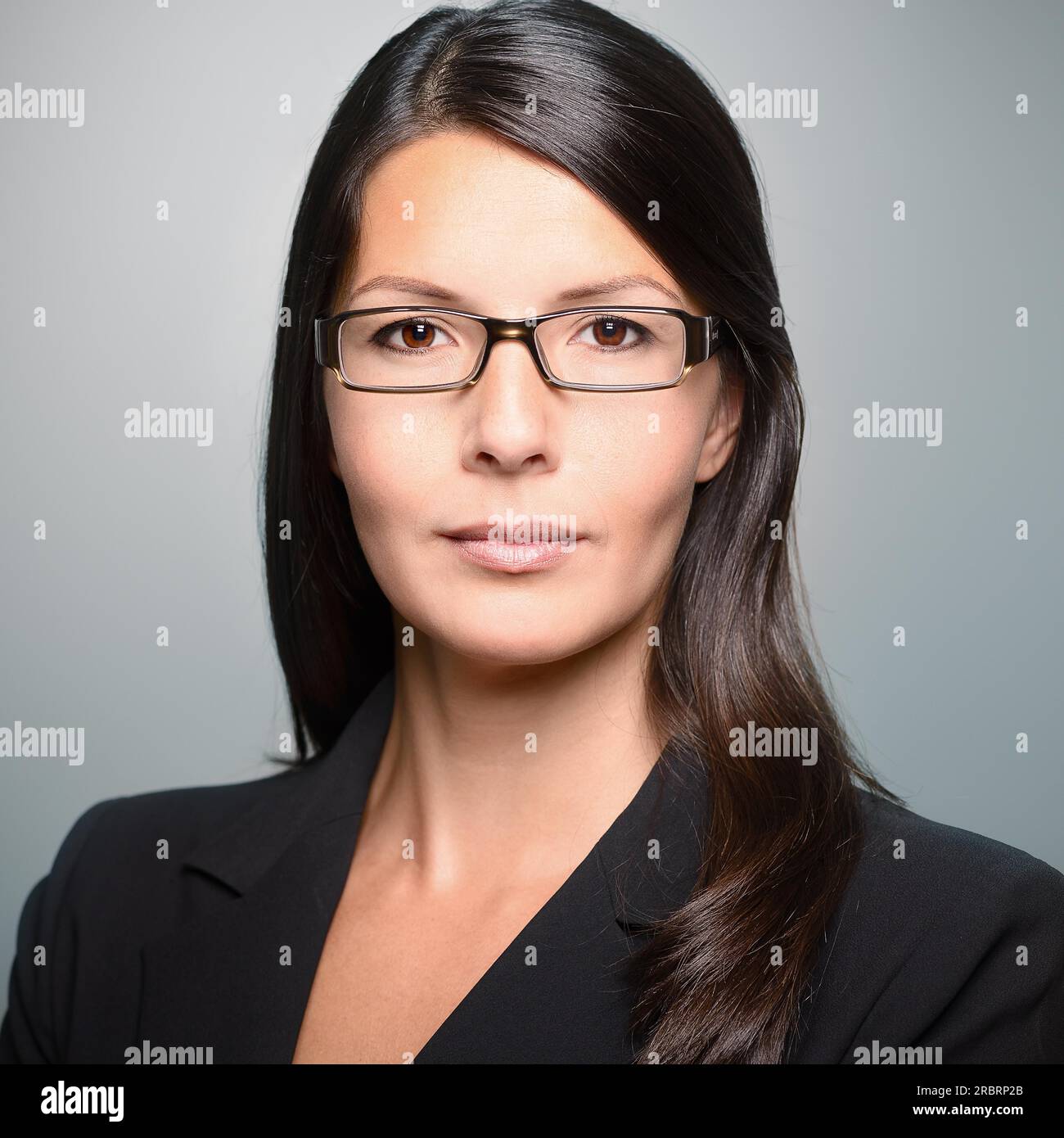 Attractive stylish young businesswoman with an attentive expression ...