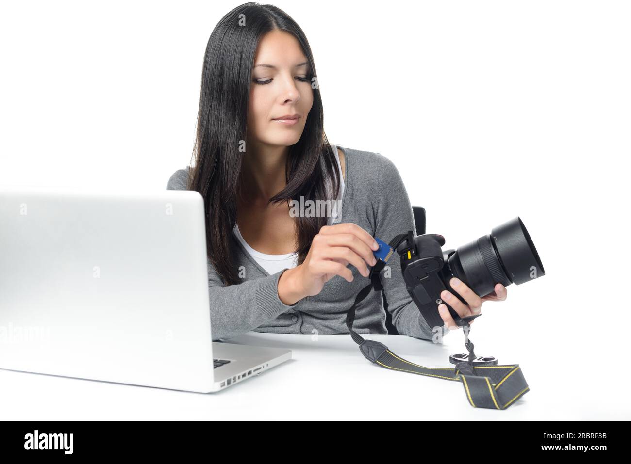 Female photographer inserting or removing a memory card in her ...