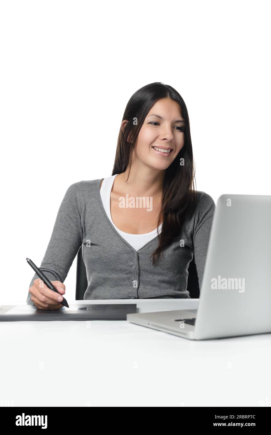 Female graphic designer smiling as she does her edits of her recently ...