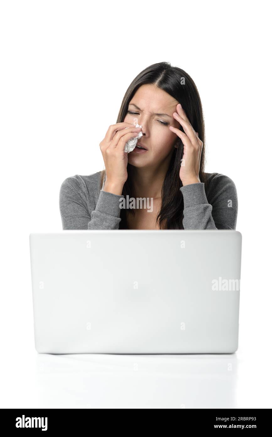Young woman with a fever and chills from seasonal influenza holding a ...