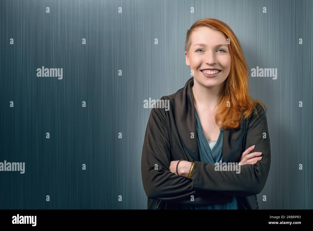 Smiling happy pretty red head woman with her long hair over one ...