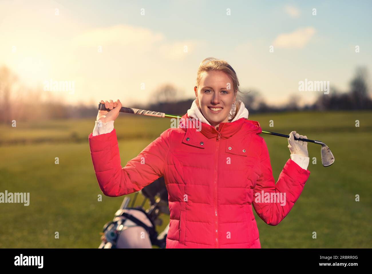 Close up Smiling Young Female Golfer in Red Jacket Holding a Golf Club ...