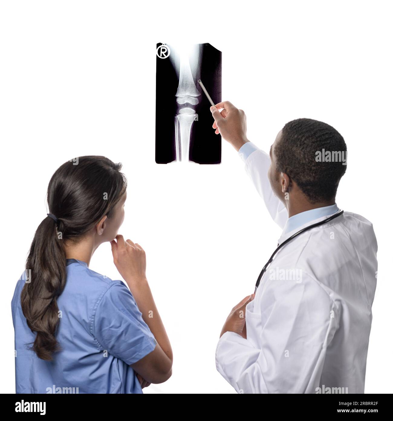 View from behind of a competent multiethnic medical team consisting of ...