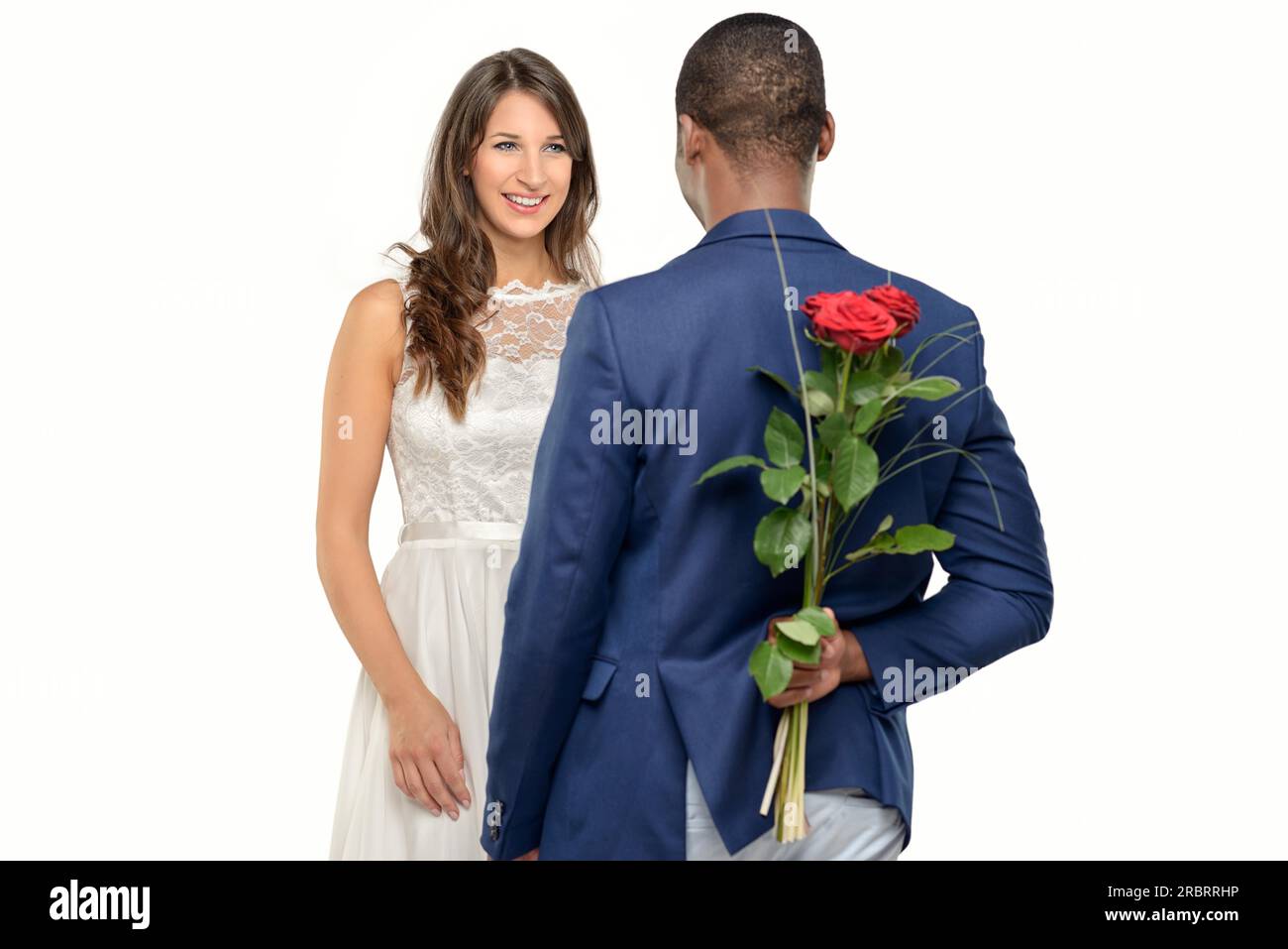 Stylish romantic African man with a red rose hidden behind his back to ...