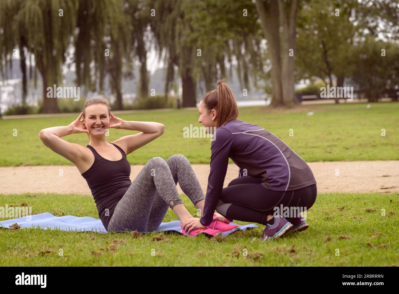 Happy Athletic Woman Smiling at the Camera While Doing Curl Up Exercise ...