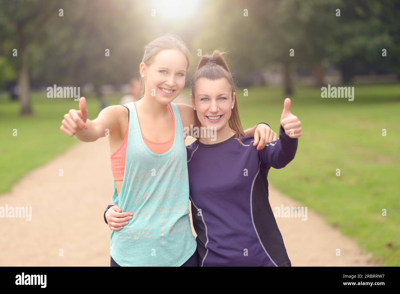 Half Body Shot of Two Happy Healthy Woman at the Park Showing Thumbs Up ...