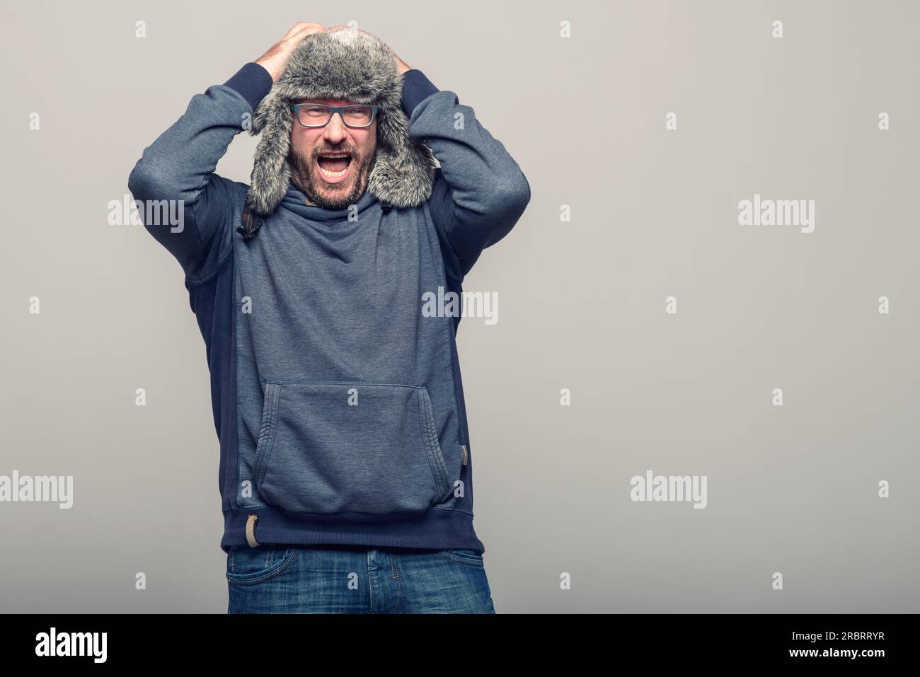 Middle-aged reacting in shock and horror with her mouth agape and hands ...