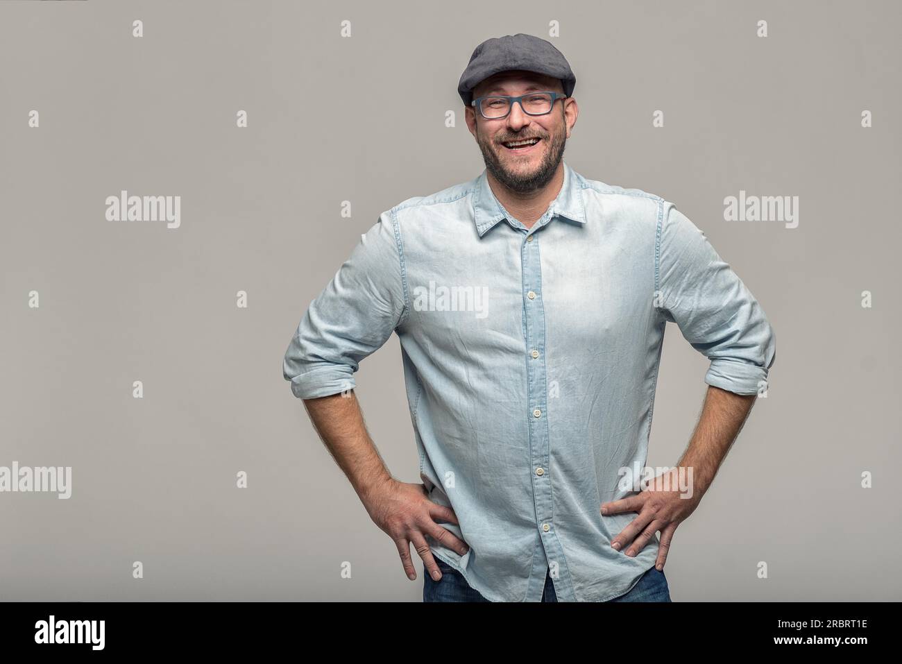 Friendly attractive man with glasses looking at the camera with a ...