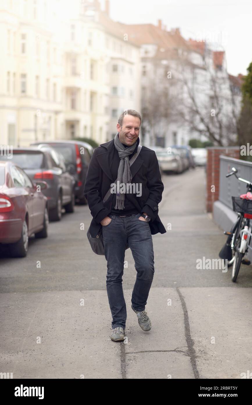 Young handsome confident fashionable man standing in an urban street in ...