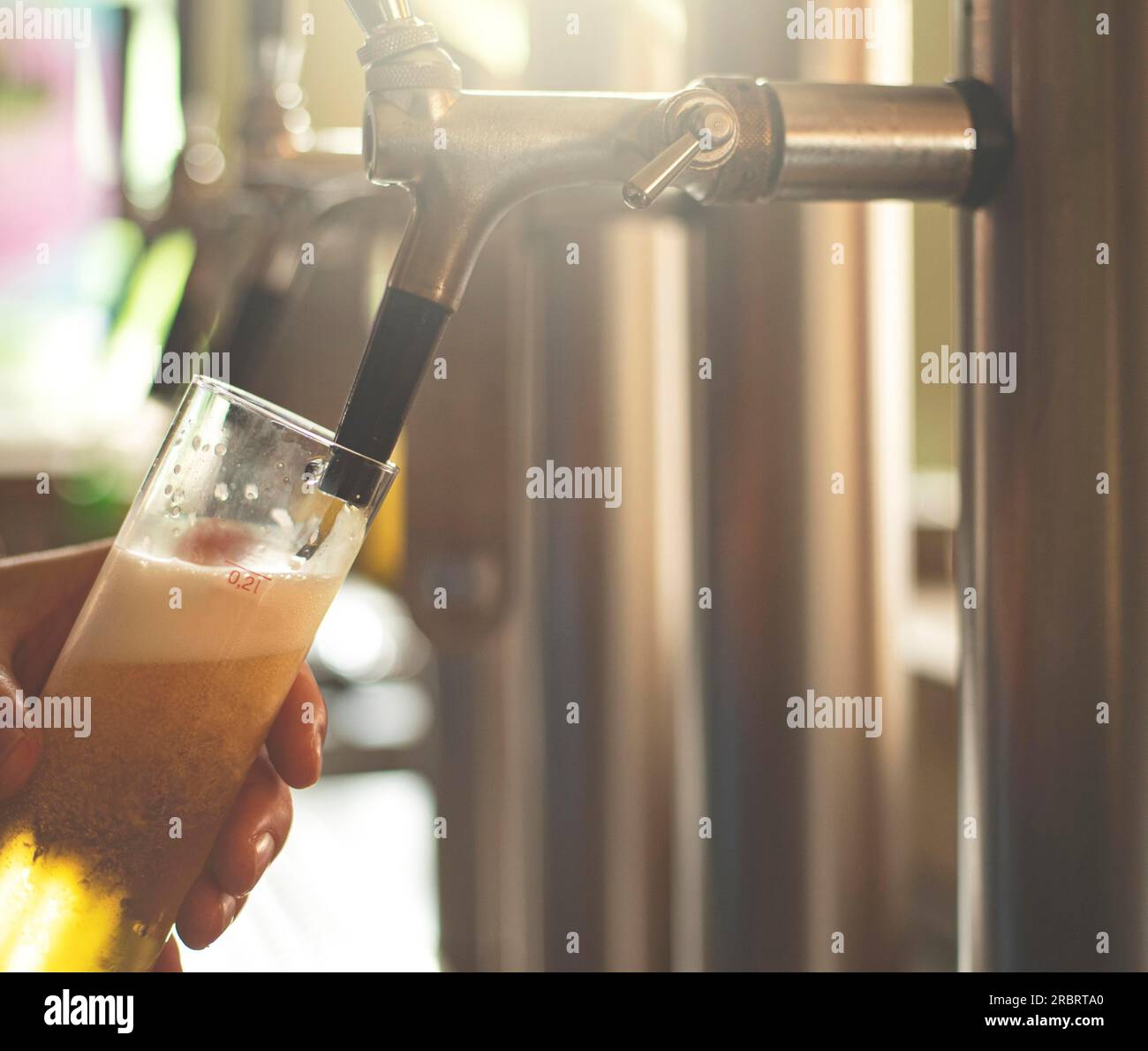 A landlord taps beer in a bar Stock Photo - Alamy