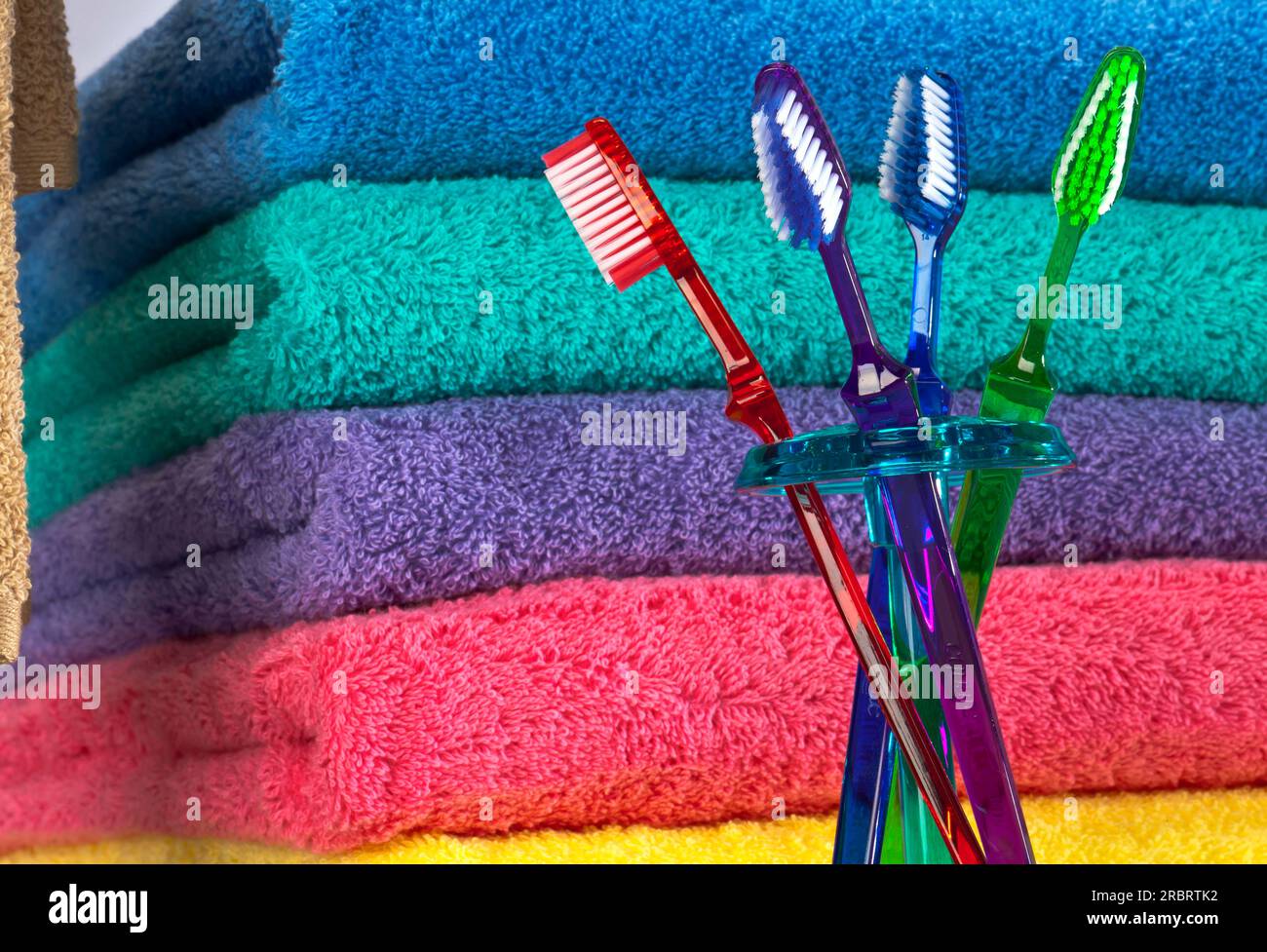 Toothbrush and bath towels against a white background in a studio ...