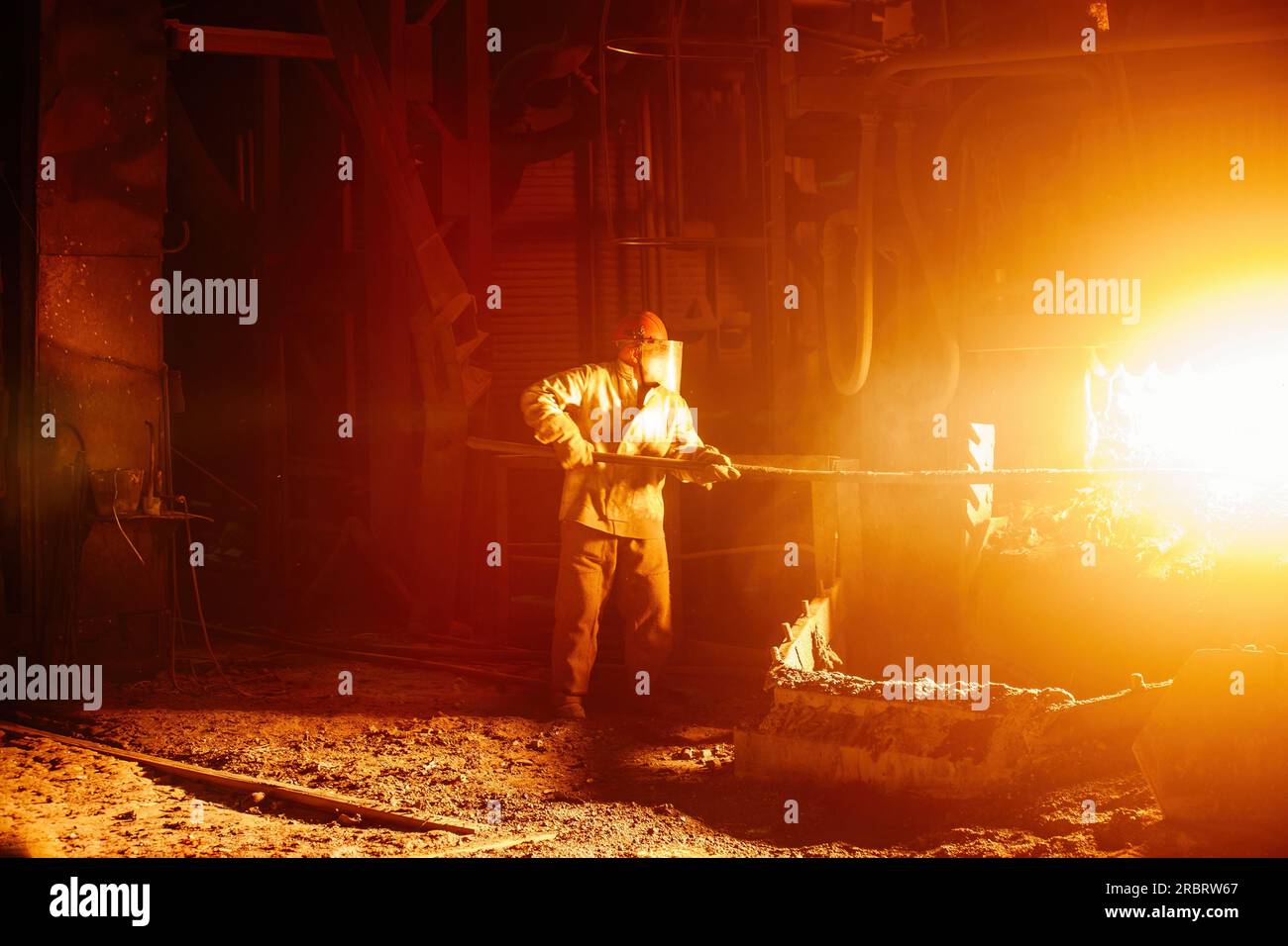 Metallurgists taking samples of liquid molten metal Stock Photo - Alamy
