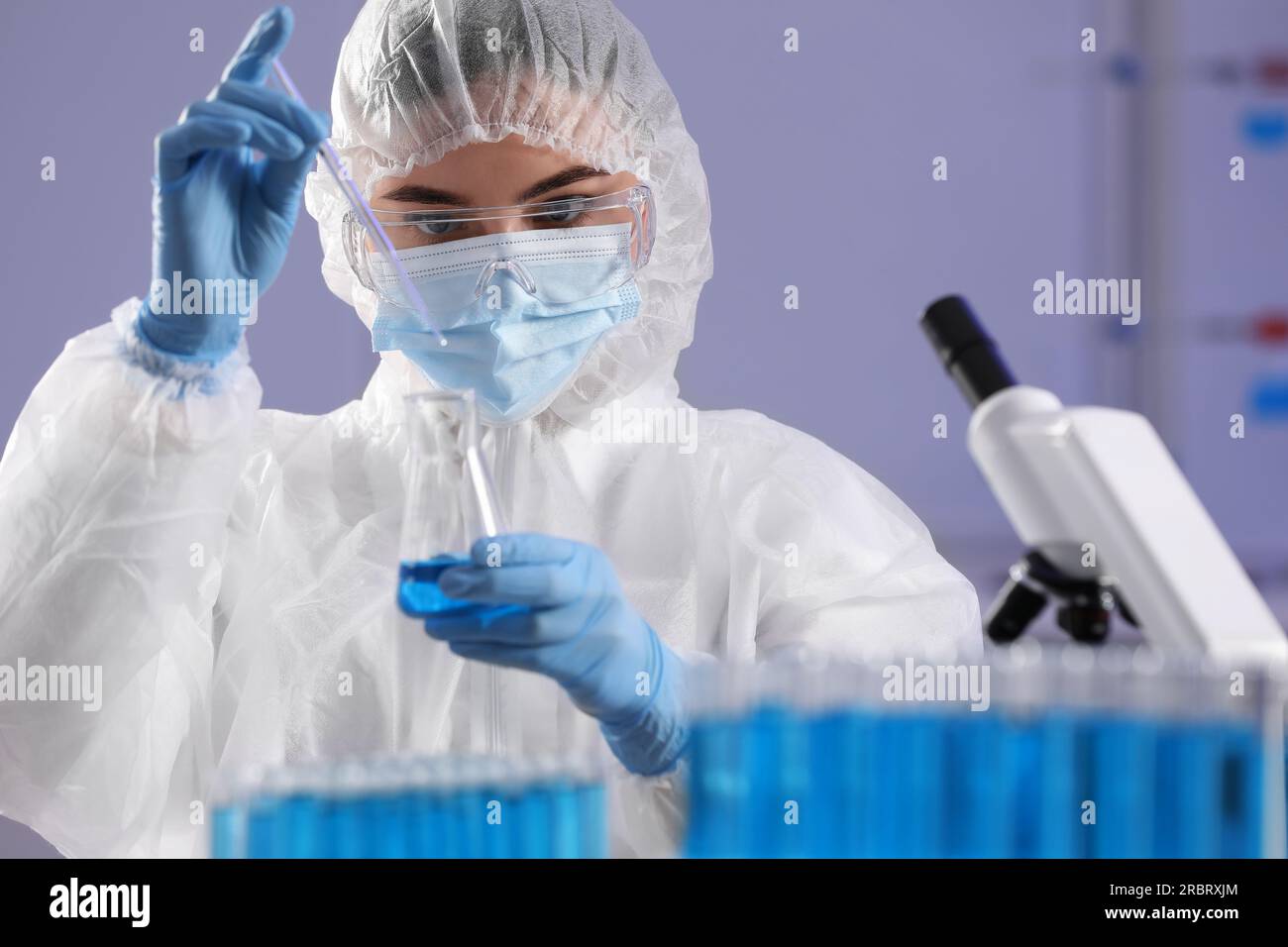 Scientist taking sample blue liquid hi-res stock photography and images - Alamy