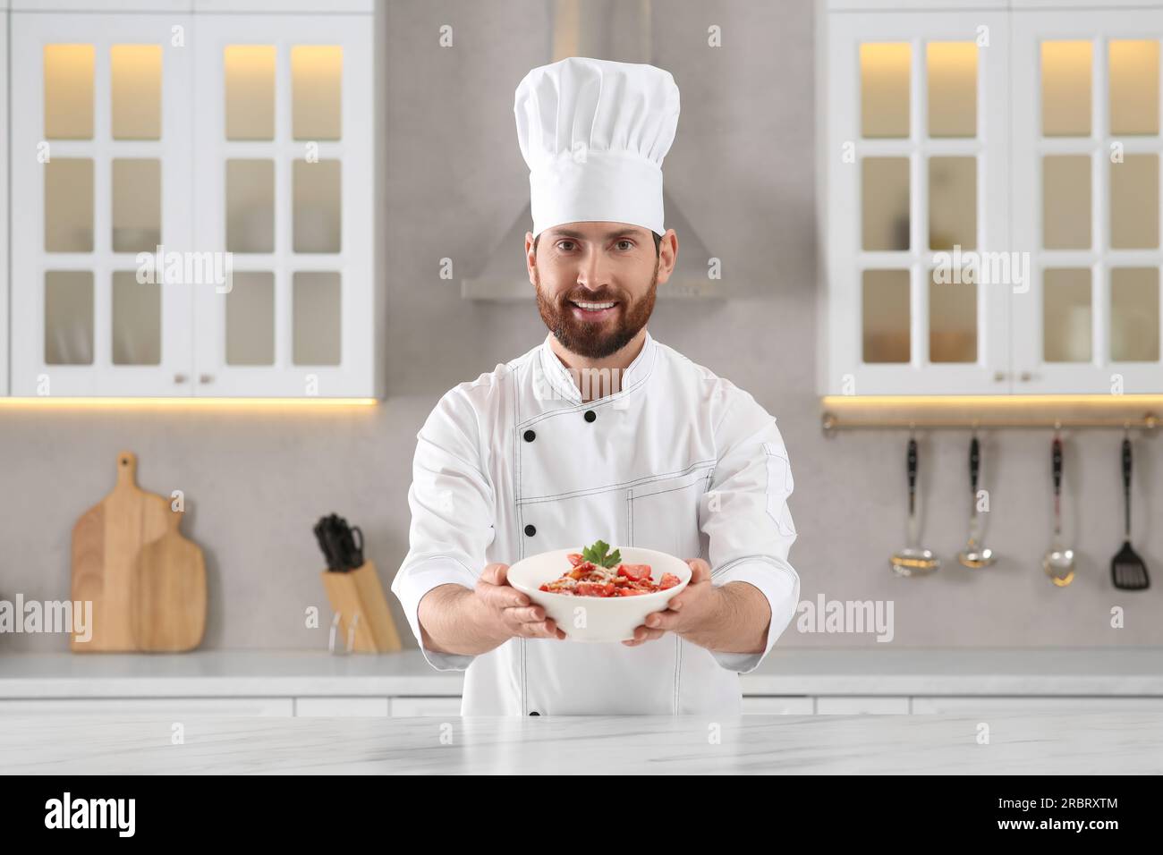 Handsome chef presenting meal hi-res stock photography and images - Alamy