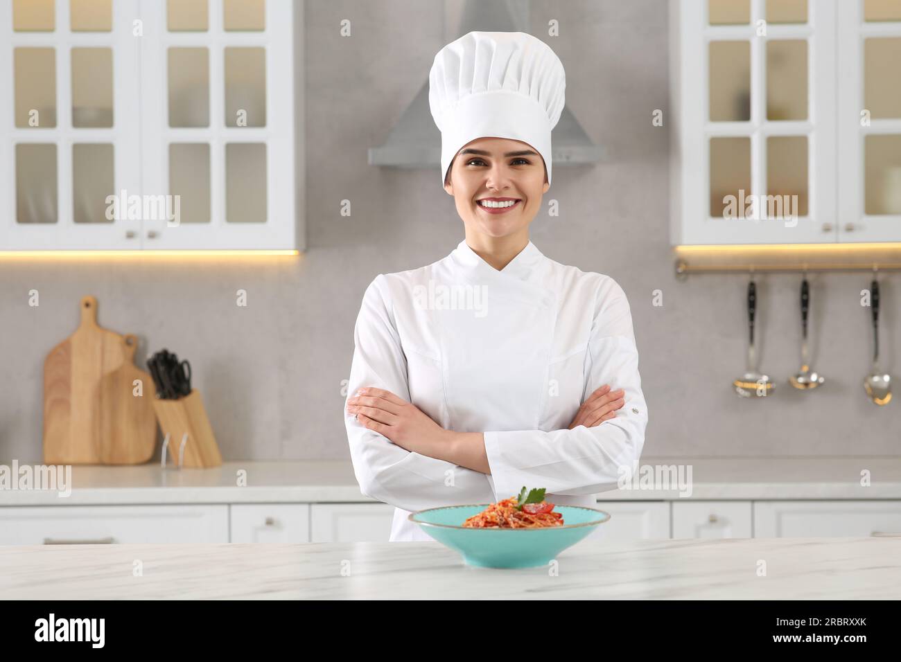Happy female chef arms crossed hi-res stock photography and images - Alamy