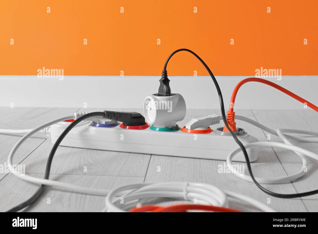 Power strip with different electrical plugs on white laminated floor ...