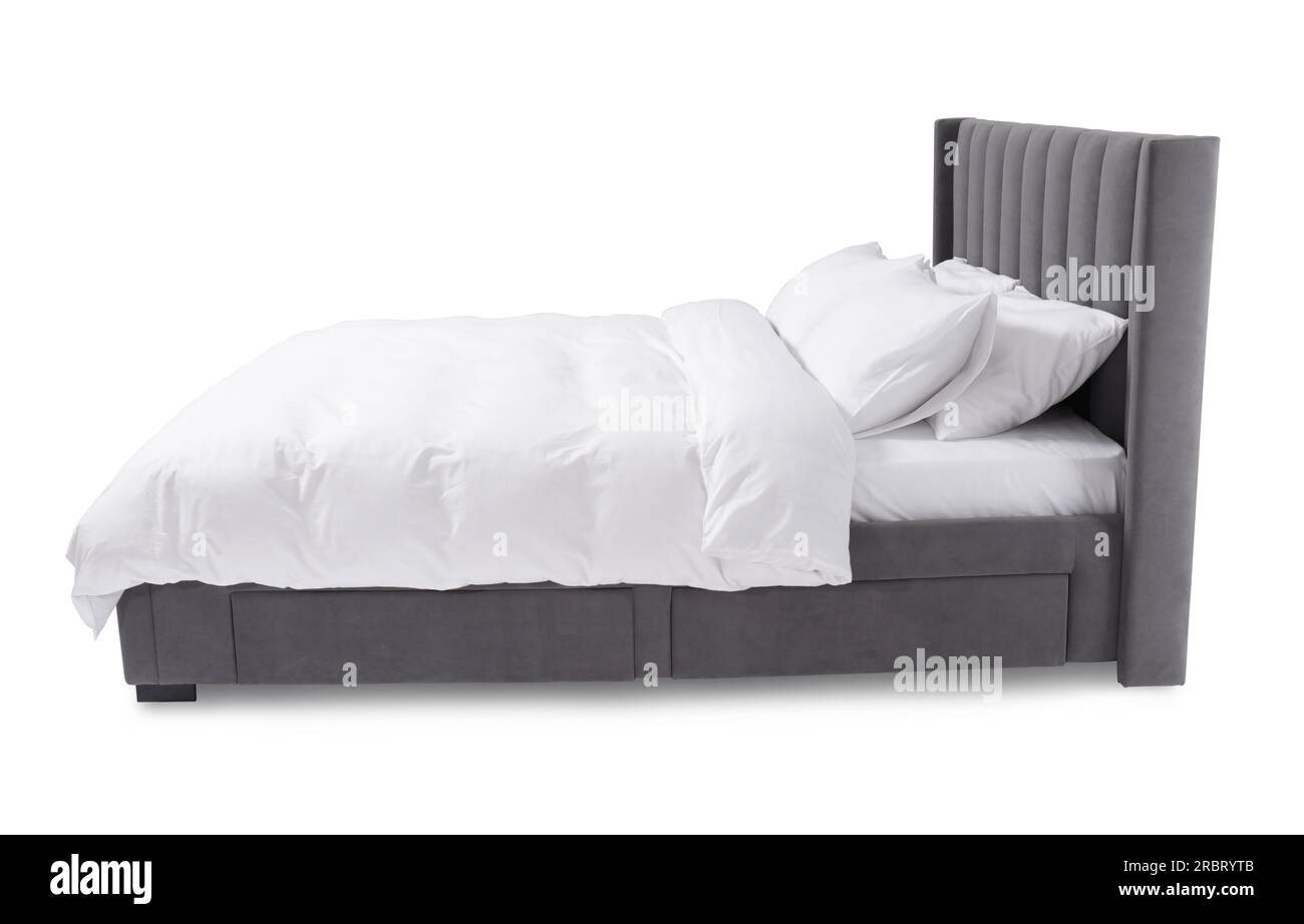 Comfortable gray bed with linens on white background Stock Photo - Alamy