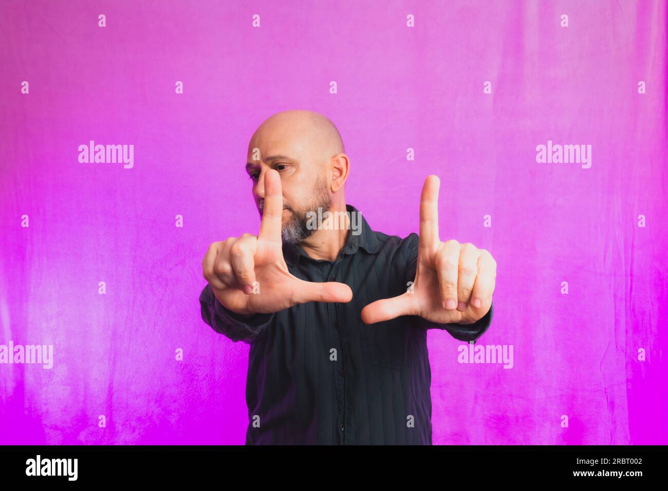 Portrait of bearded and bald man making signs with hands. Isolated on ...