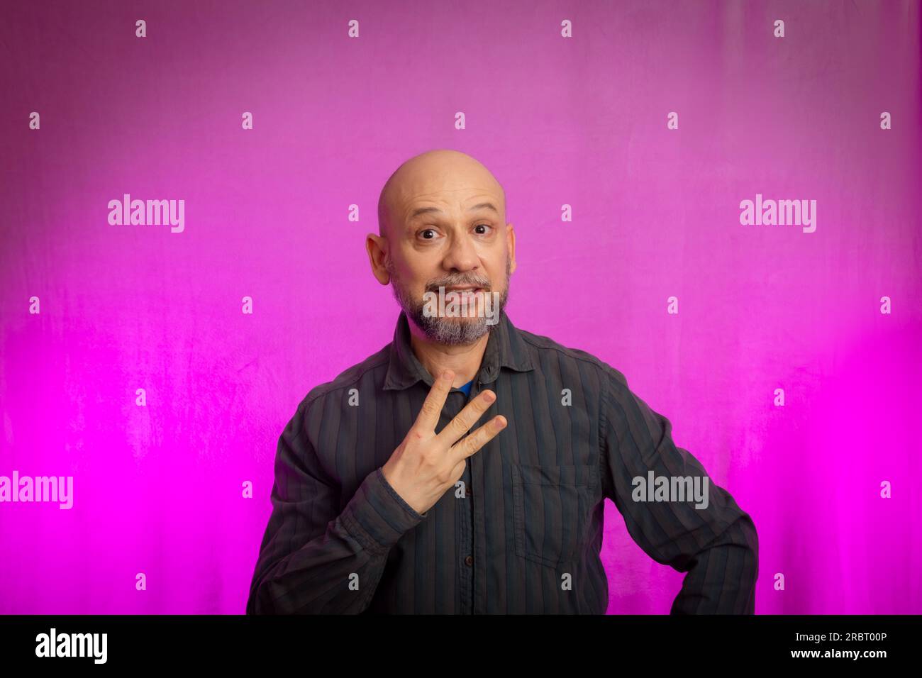 Portrait of bearded and bald man making signs with hands. Isolated on ...