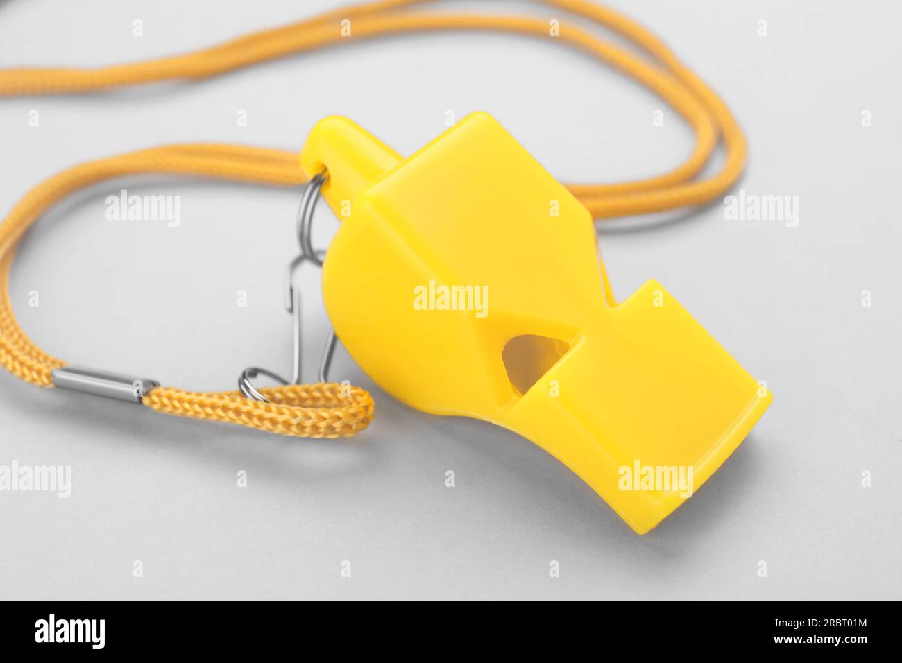 One yellow whistle with cord on white background, closeup Stock Photo ...