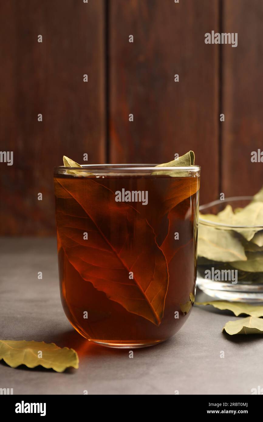 Cup of freshly brewed tea with bay leaves on grey table Stock Photo - Alamy