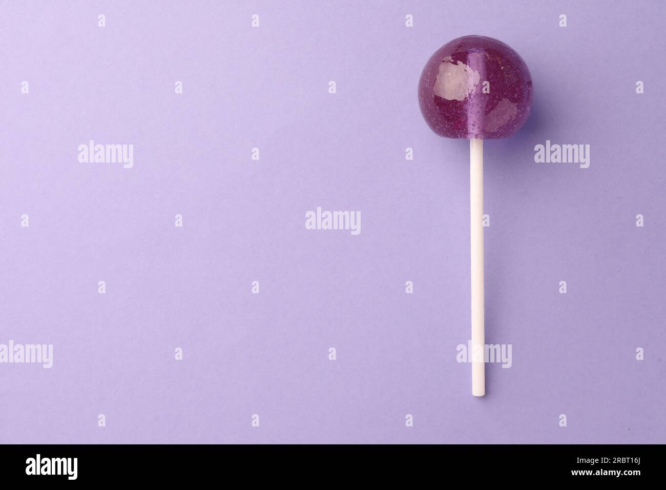 Tasty lollipop on violet background, top view. Space for text Stock ...