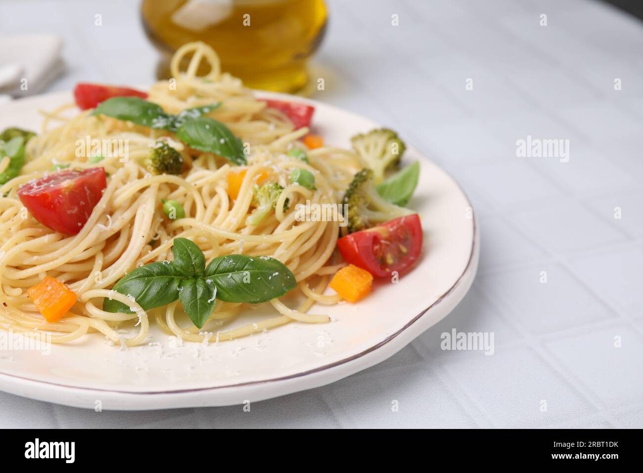 Delicious pasta primavera with tomatoes, basil and broccoli on white ...