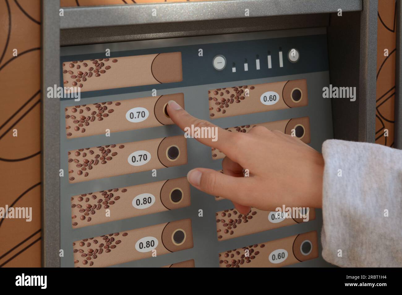 Using coffee vending machine. Woman pressing button to choose drink ...