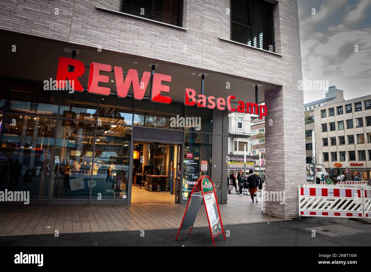Picture of a sign with the logo of Rewe on their main store in Dortmund ...