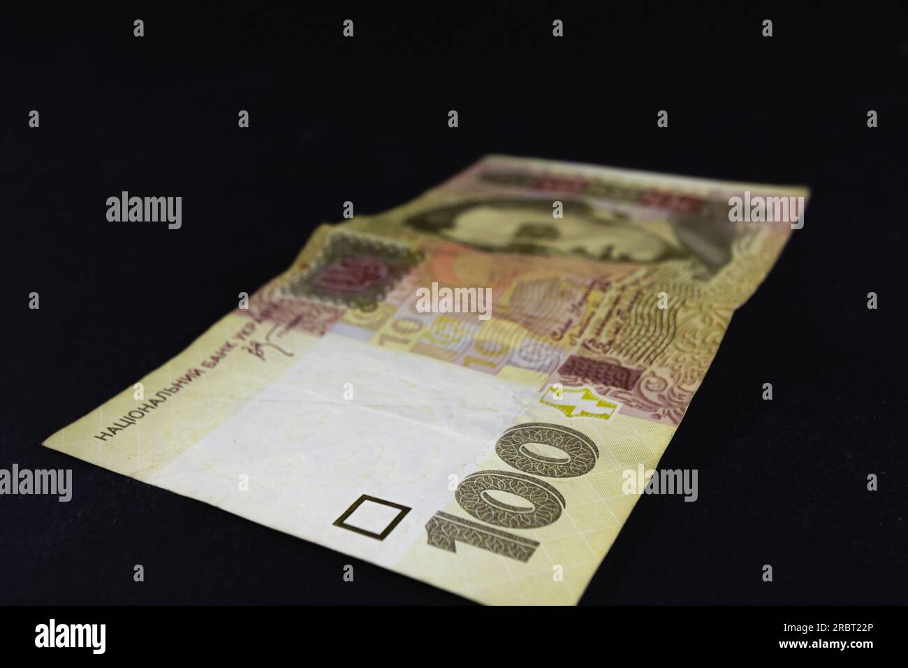 Picture of a ukrainian banknote of 100 hryvnia isolated on a black ...