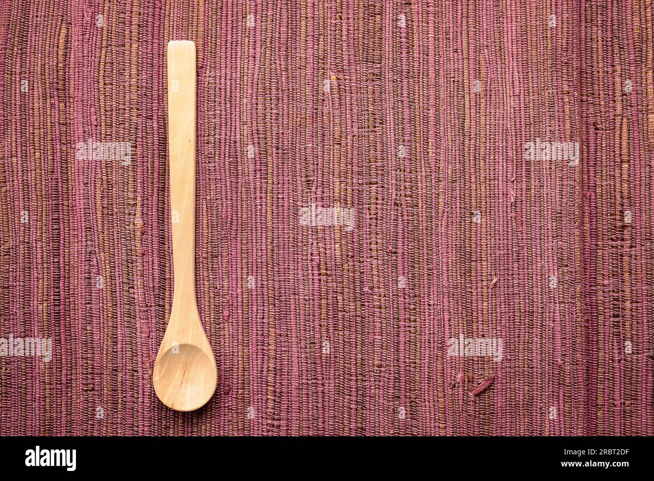 Wooden spoon on a colorful violet textile Stock Photo - Alamy