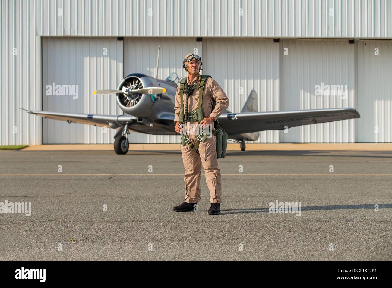 A WWII military pilot with his SNJ5 aircraft returning from a mission ...