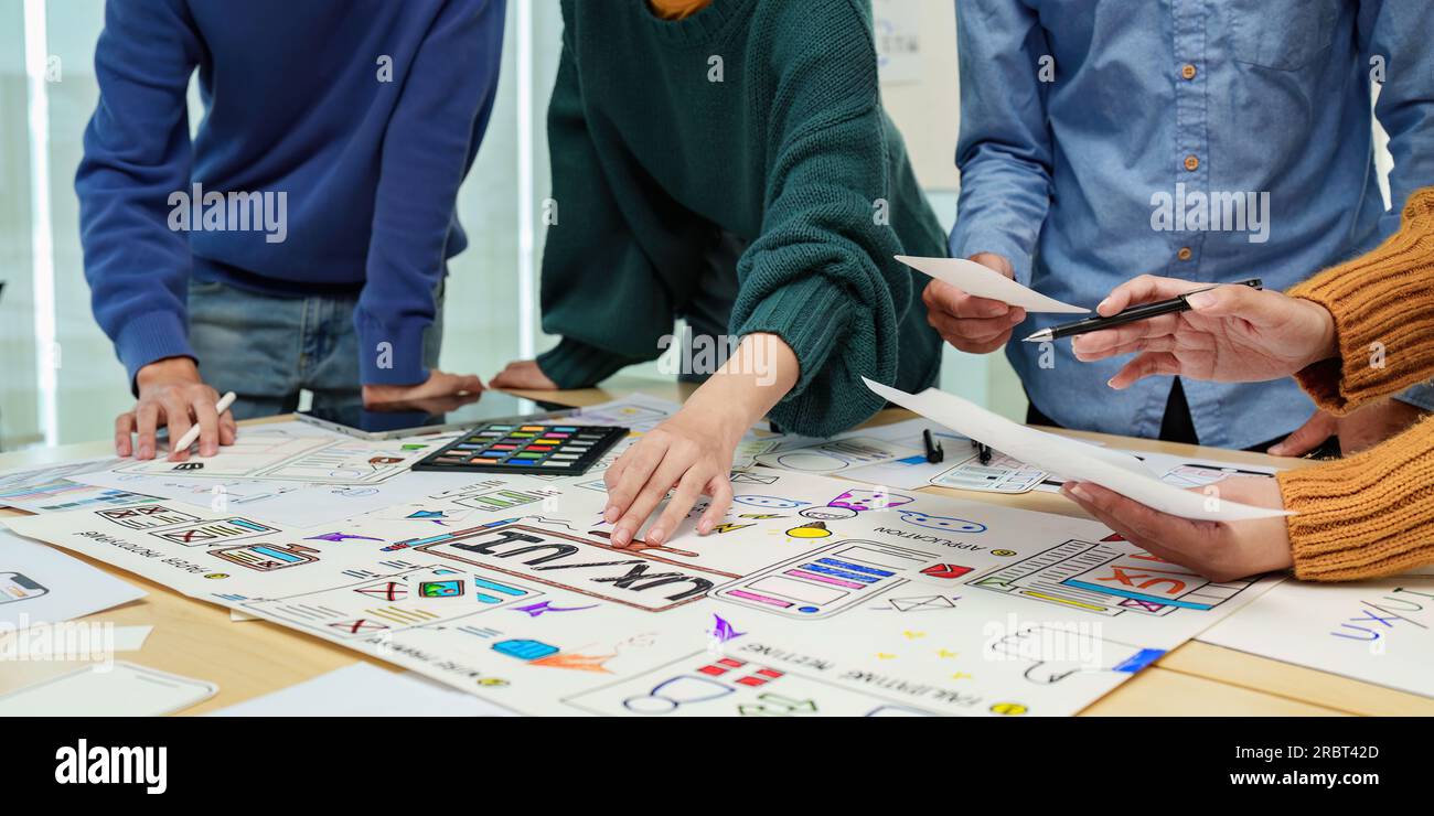 Close up ux developer and ui designer brainstorming interface wireframe ...