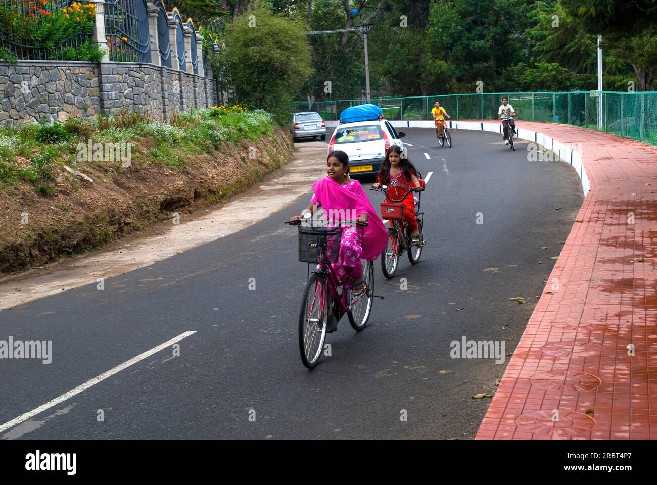 Children riding bicycle around the lake road at Kodaikanal, Tamil Nadu ...