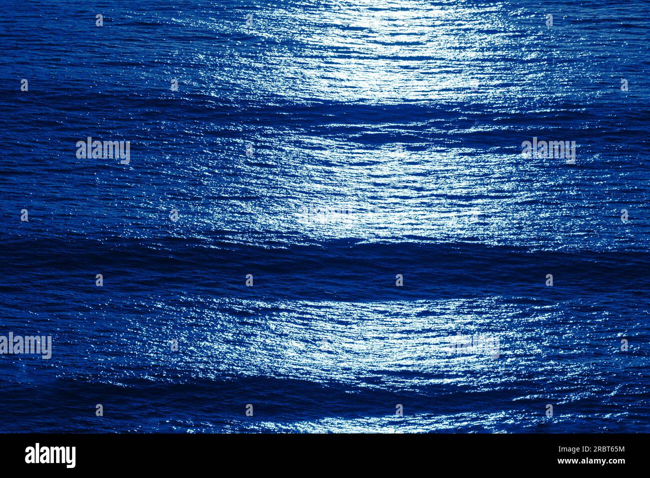 Moonlight and ocean waves . Light reflection in blue sea Stock Photo ...