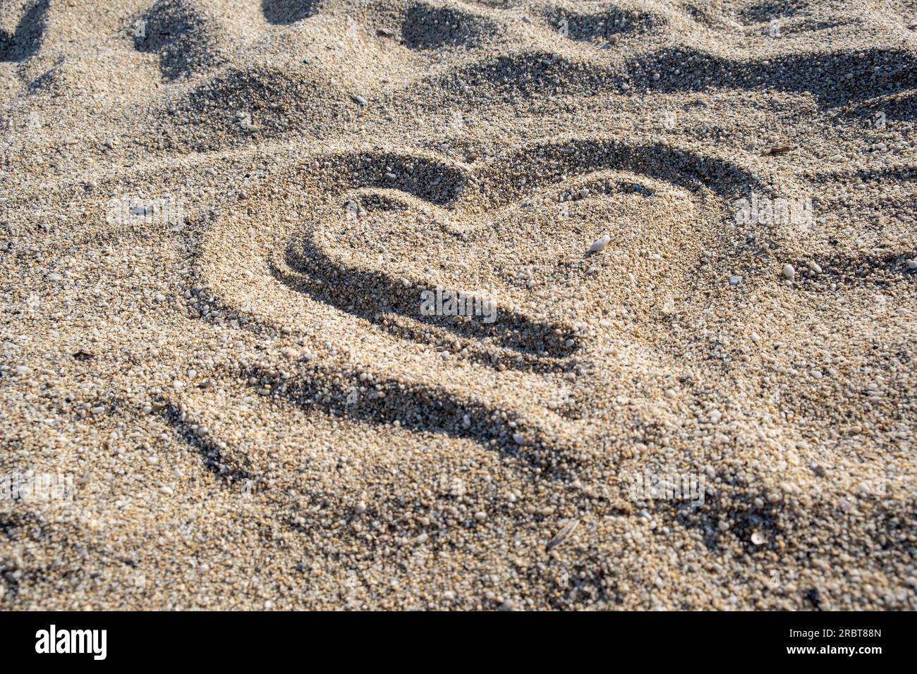 Heart shape and footprint on wet sand Stock Photo - Alamy