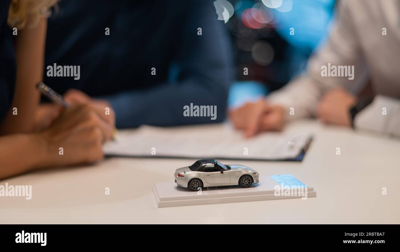 Signing papers at dealership hi-res stock photography and images - Alamy