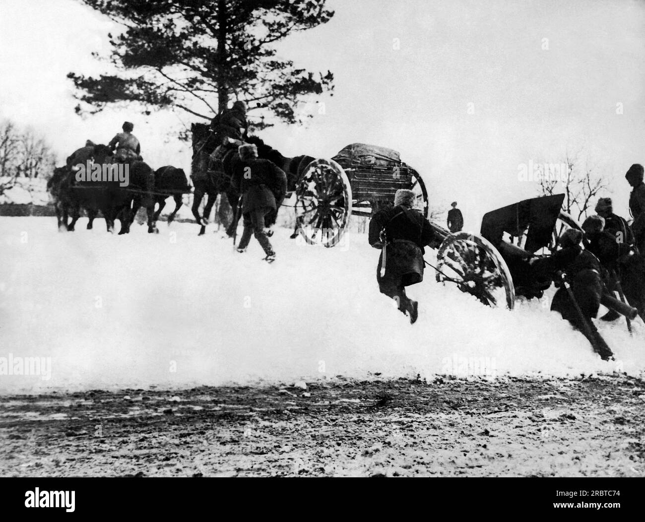 Europe: c. 1917 Russian troops struggling to bring up wagons and ...