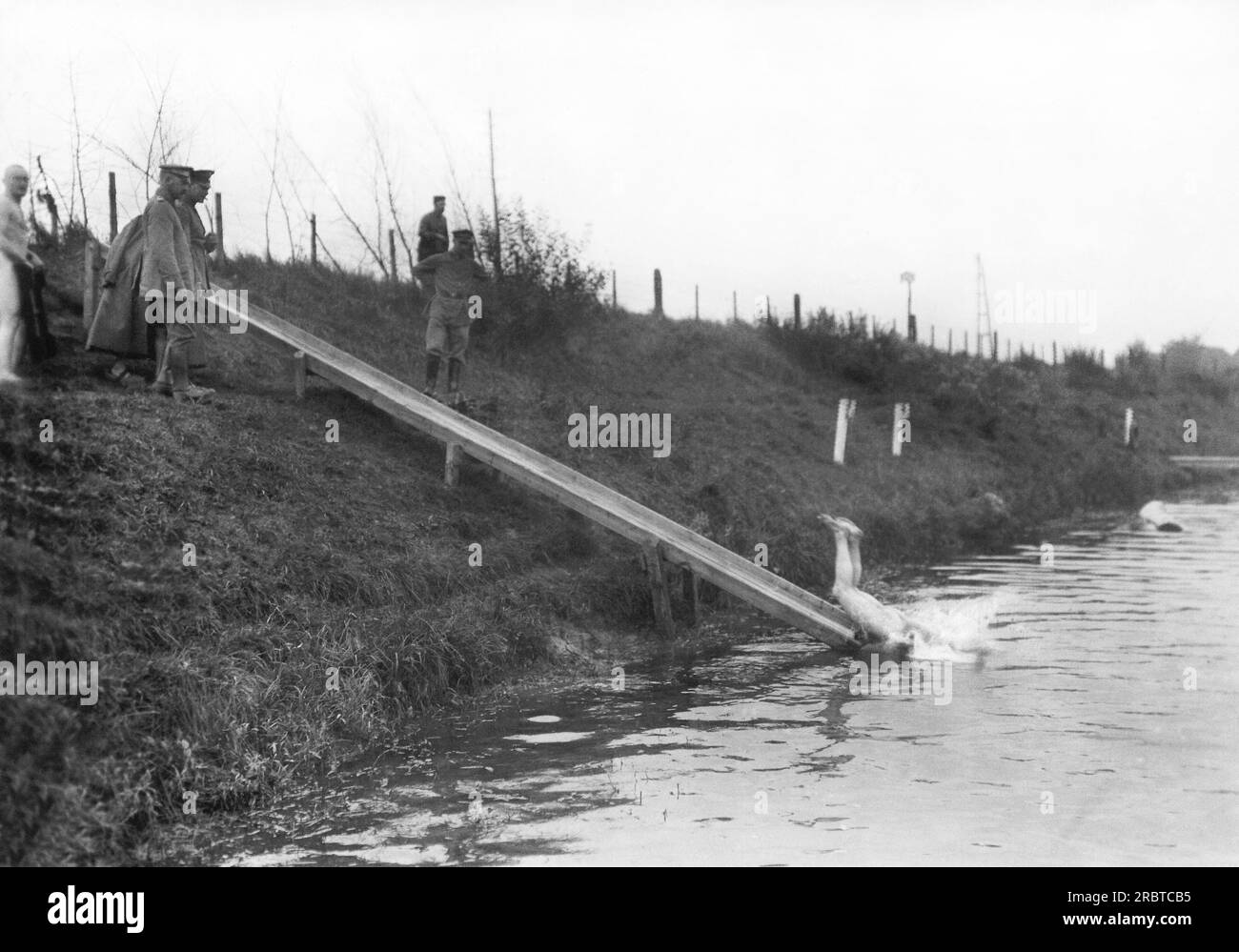Flanders, Belgium: c. 1916 German soldiers slide down a waterchute they ...