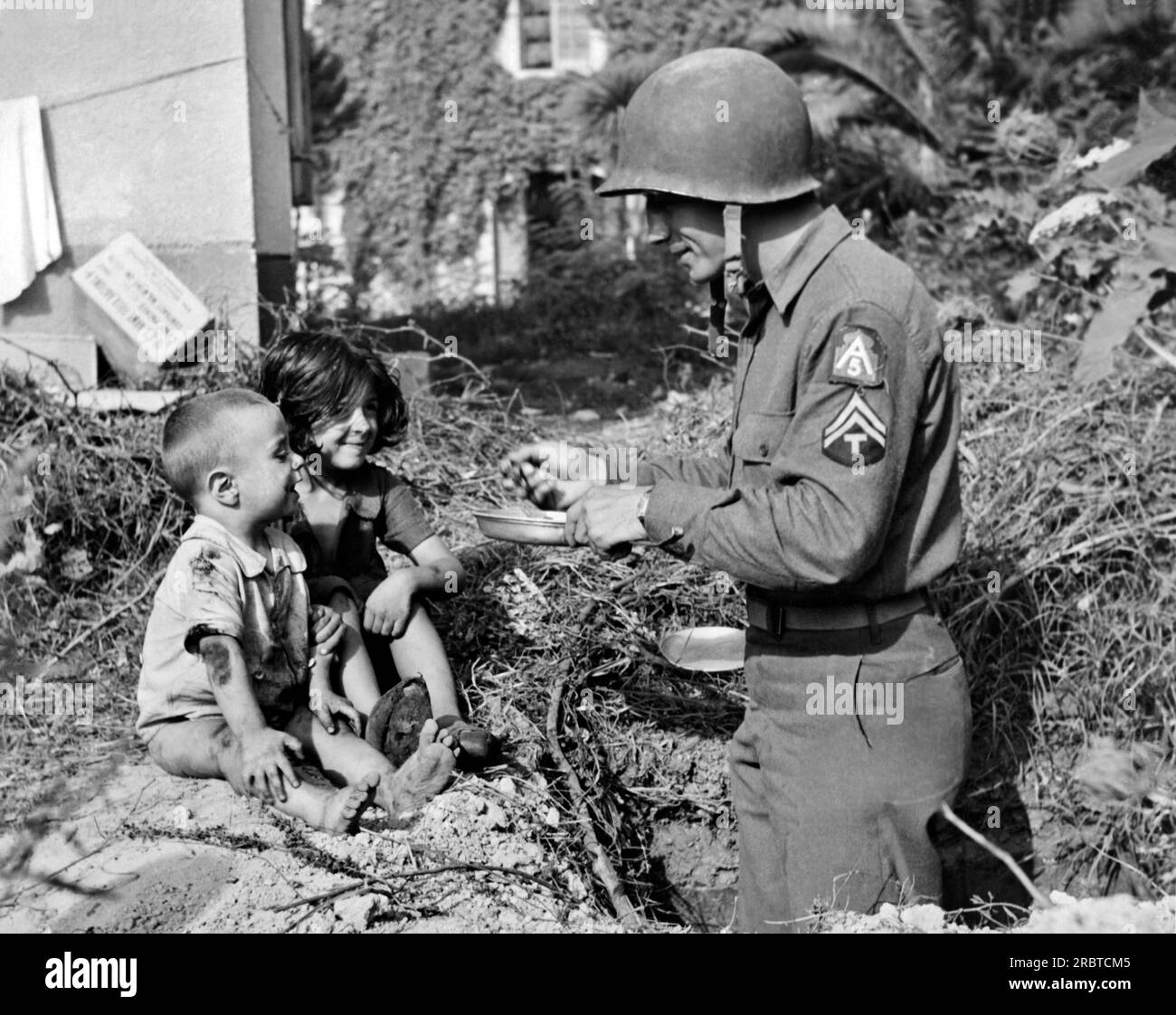 Italy: October 6, 1943 An American soldier shares his rations with two ...