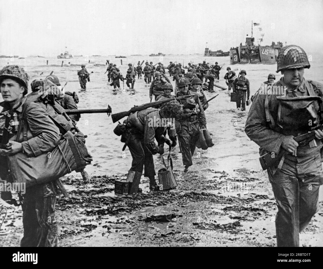 France: June 10, 1944 Allied soldiers wade ashore after disembarking ...
