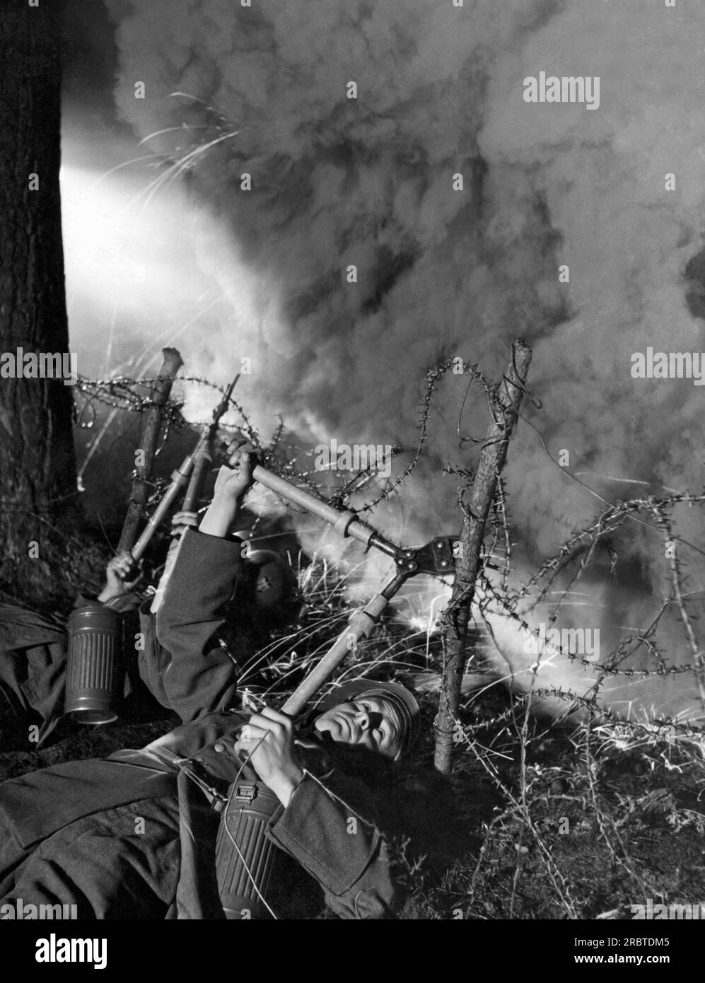 Europe: c. 1942. Two German shock troops work to clear a pathway ...