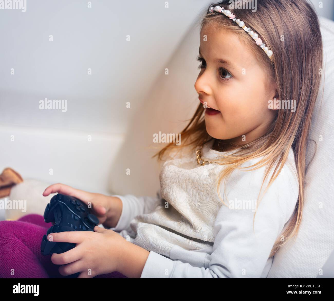 A little girl experiences exciting challenges playing video games at ...