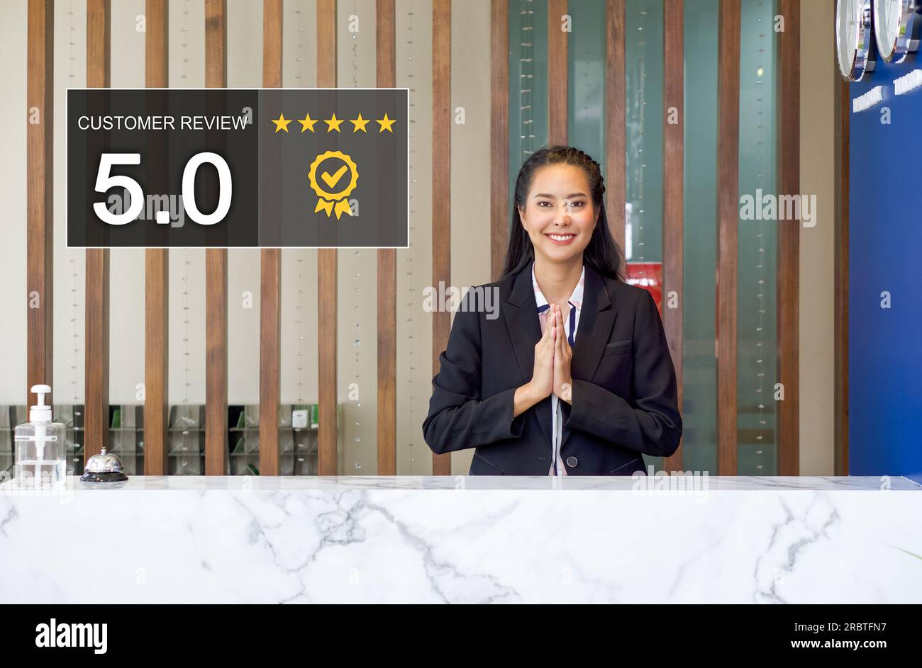 Hotel receptionist raise her hand to pay respect in thai culture, shows ...