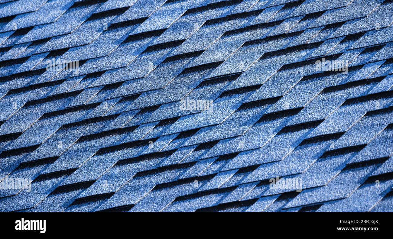 Modern blue roof tiling made of flexible shingles, panoramic background ...